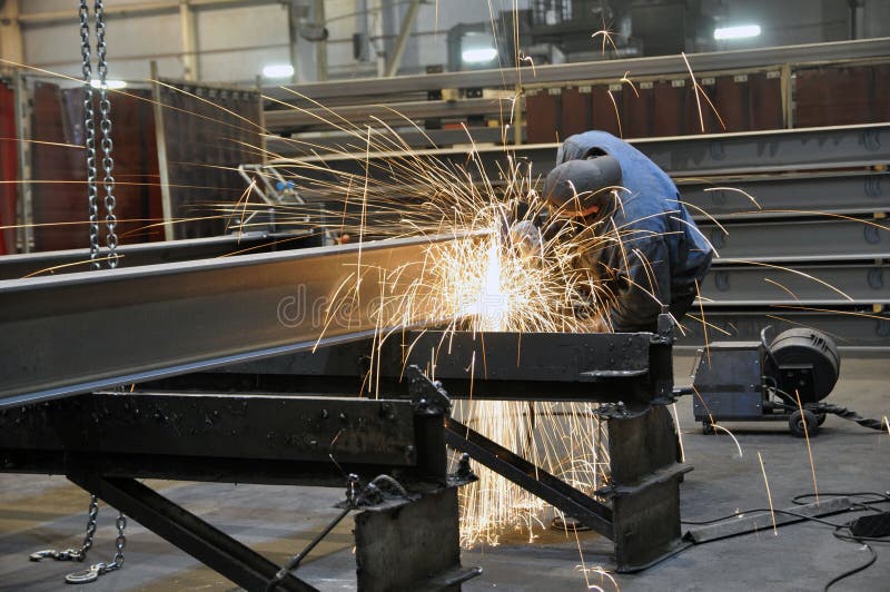 A Worker in a Factory is Cleaning the Steel Structure of an Angle ...