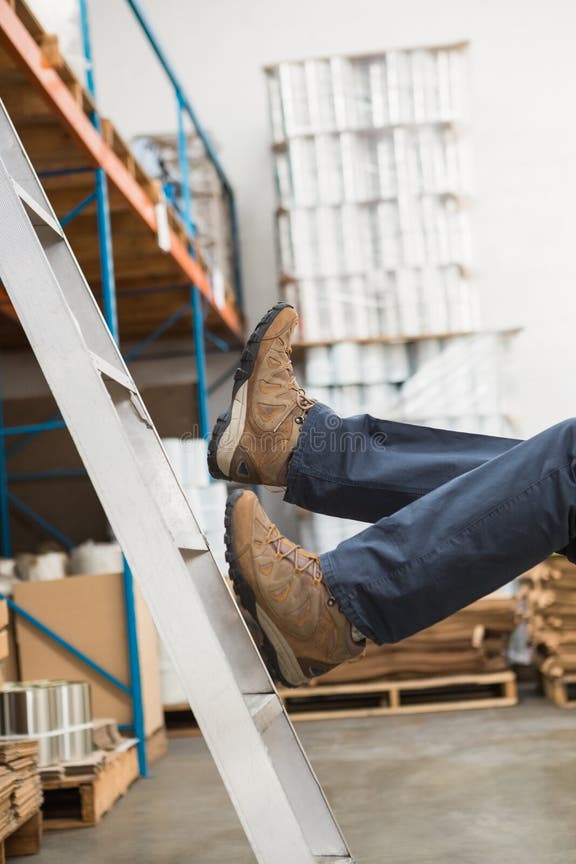Worker Falling Off Ladder in Warehouse Stock Photo - Image of ...