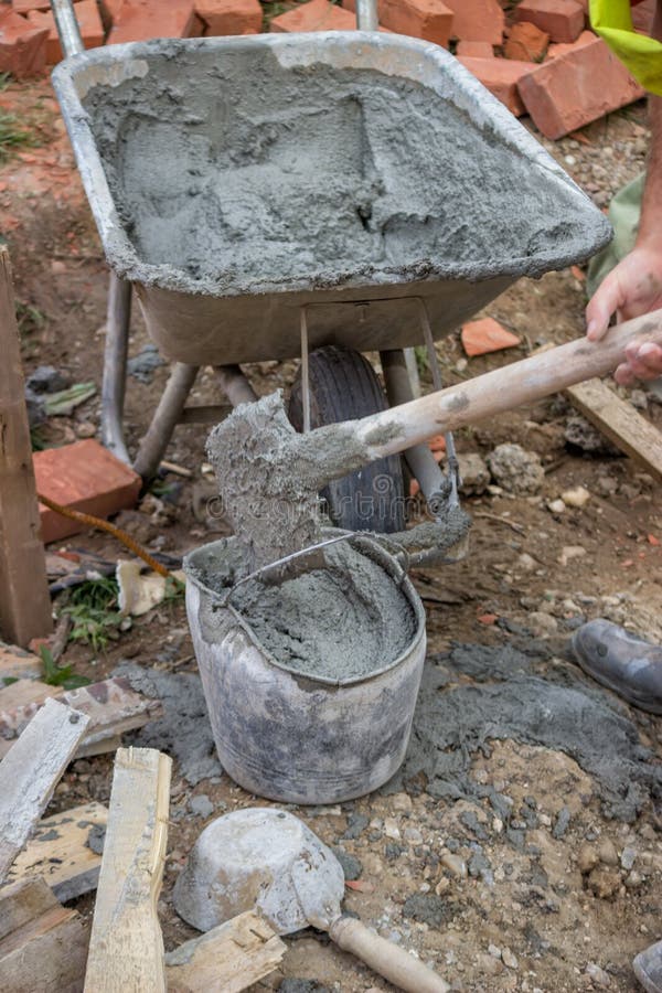 Worker Filling a Bucket of Mortar 2 Stock Image - Image of bricklaying ...