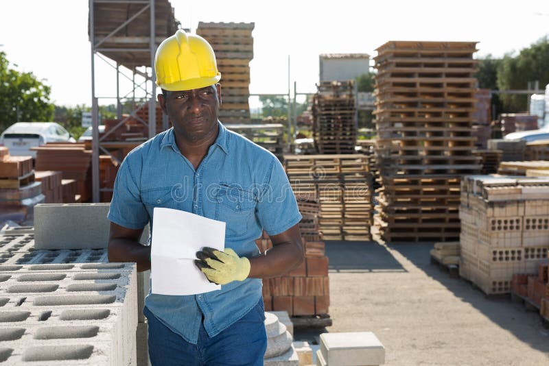 Worker Filling Documentation beside Hollow Block Stack Outdoors Stock ...
