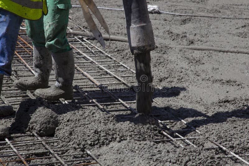 Worker Filling the Foundation Slab of a Building Under Construction ...