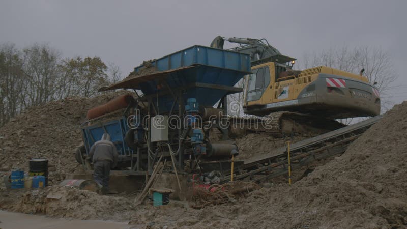 Worker by Filtering Machine and Excavator in Clay Quarry Stock Video ...