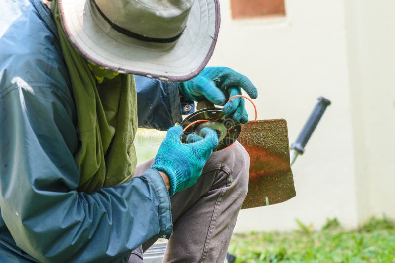 Worker fix the lawn mower. editorial stock image. Image of mowing ...