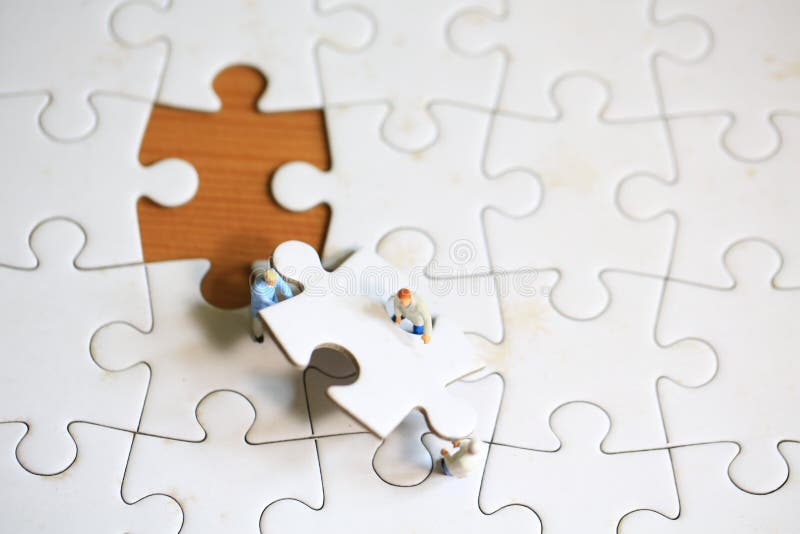 Worker Fix the Puzzle on the Table, Together Work Hard To Solve the ...