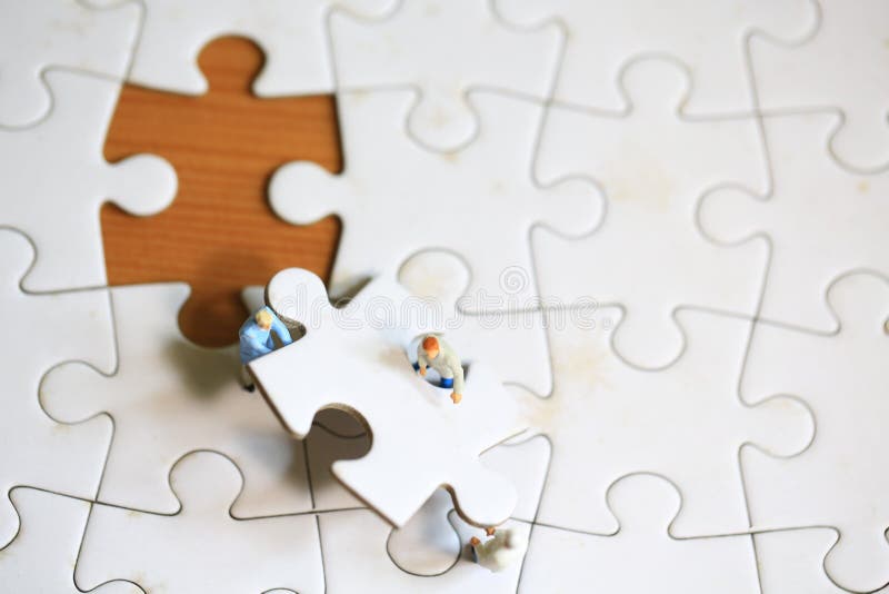 Worker Fix the Puzzle on the Table, Together Work Hard To Solve the ...