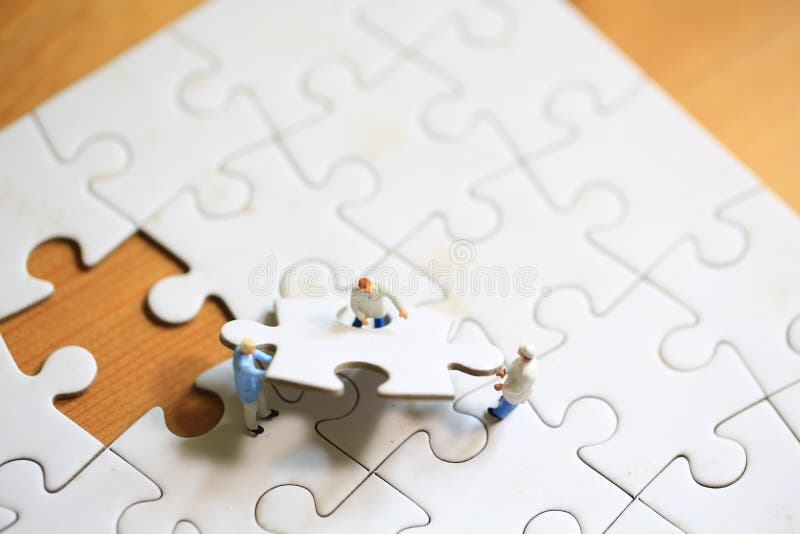 Worker Fix the Puzzle on the Table, Together Work Hard To Solve the ...