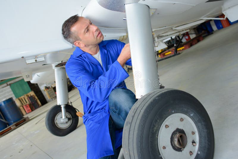 Man fixing aircraft`s wing stock image. Image of flight - 86208661