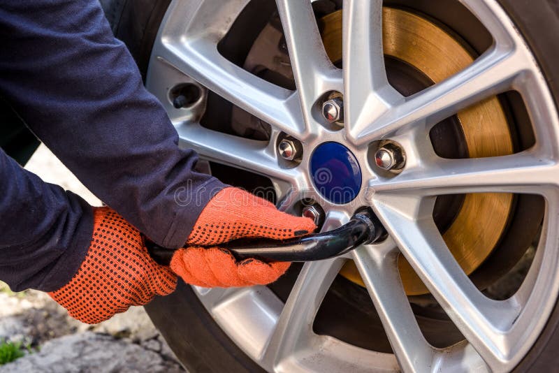 Worker Fixing Car Wheel with Spanner Close Up Stock Image - Image of ...