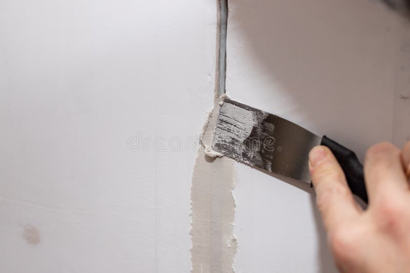 Worker Fixing Cracks on Ceiling, Spreading Plaster Using Trowel ...
