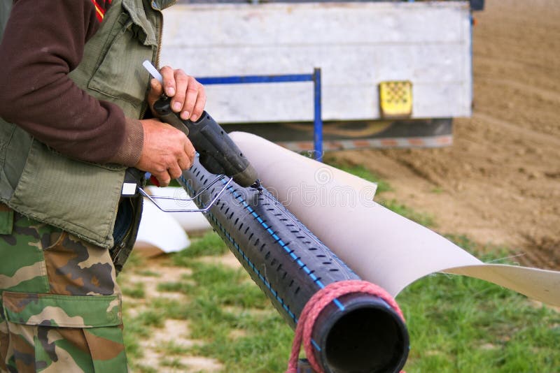 Worker Fixing Filter Paper on Perforated Tube Stock Photo - Image of ...