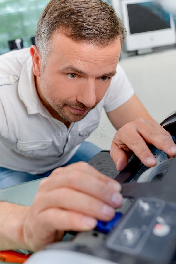Worker fixing printer stock photo. Image of printer - 261513108