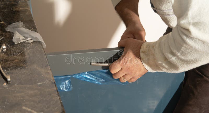 Worker Fixing Kitchen Cabinet Using Screwdriver Stock Image - Image of ...