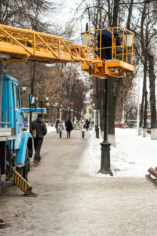 Worker Fixing a Ornamental Street Light Editorial Stock Image - Image ...