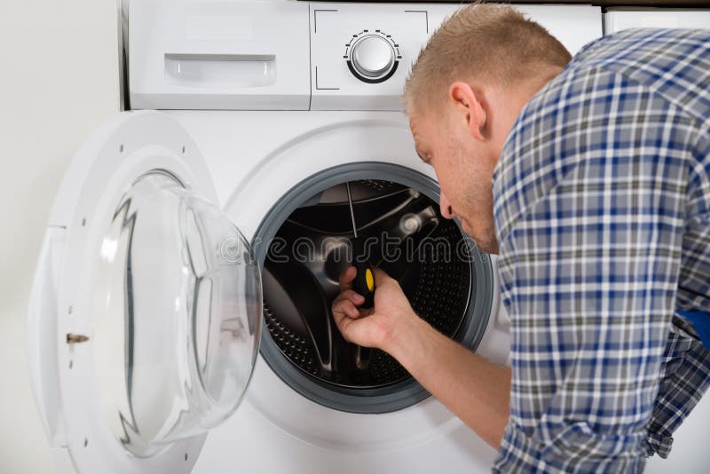 Worker Fixing Washing Machine Stock Photo - Image of holding, people ...