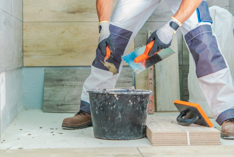 Skilled Worker Performing Tile Installation in a Modern Interior Space ...