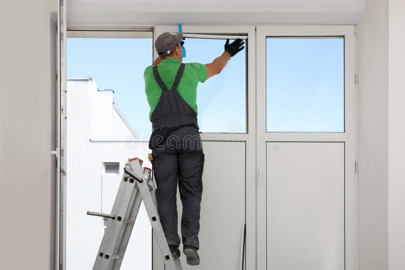 Worker on Folding Ladder Installing Window Indoors, Back View Stock ...