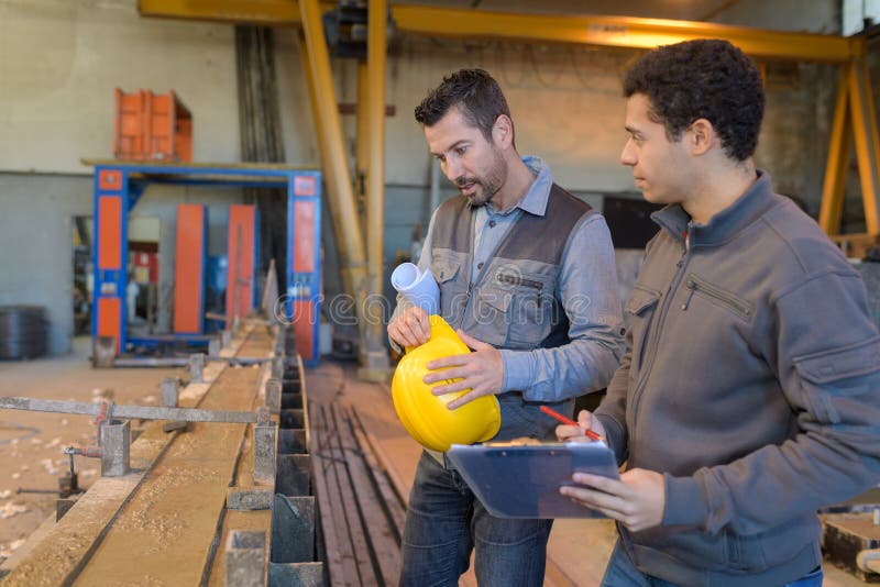 Worker and Foreman Performing Quality Check on Factory Stock Photo ...