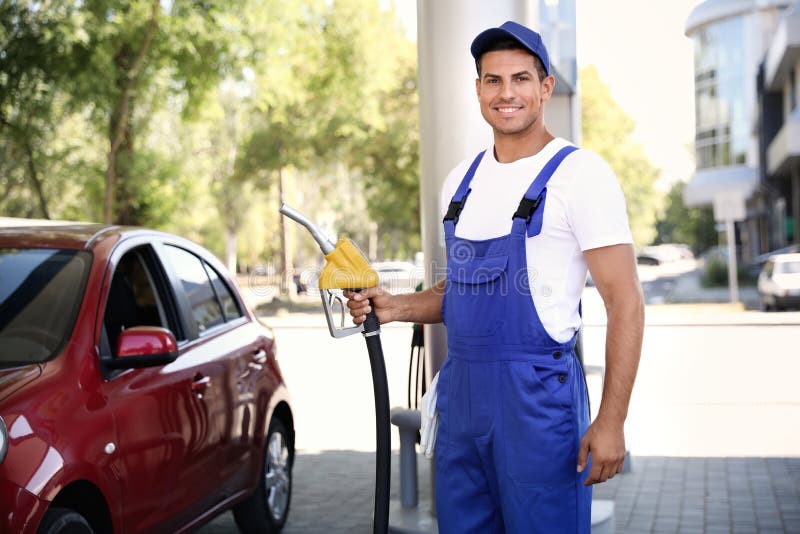 Worker with Fuel Pump Nozzle at Gas Station Stock Photo - Image of ...