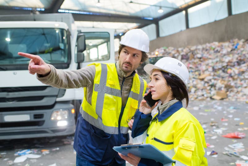 Worker Giving Instructions To Female Colleague in Refuse Center Stock ...