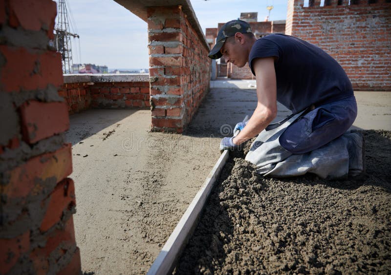 Worker in Gloves Leveling Concrete Slab Using Trowel. Stock Image ...