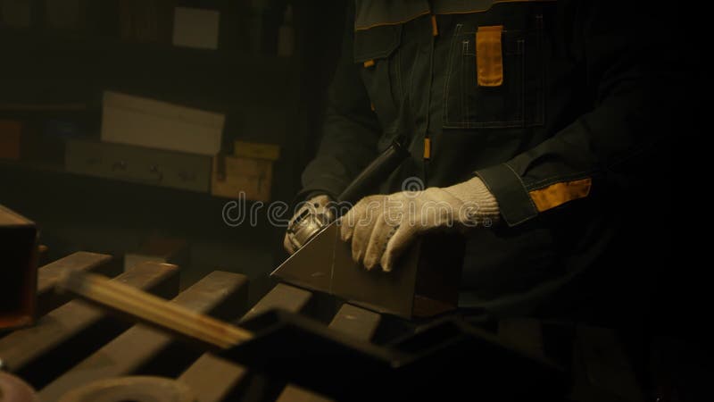 Worker Grinding Iron. Heavy Industry Factory Interior with Worker Using ...