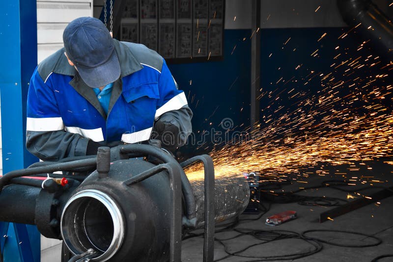 Worker Grinding Metal Pipe in Workshop with Sparks Flying Stock Photo ...