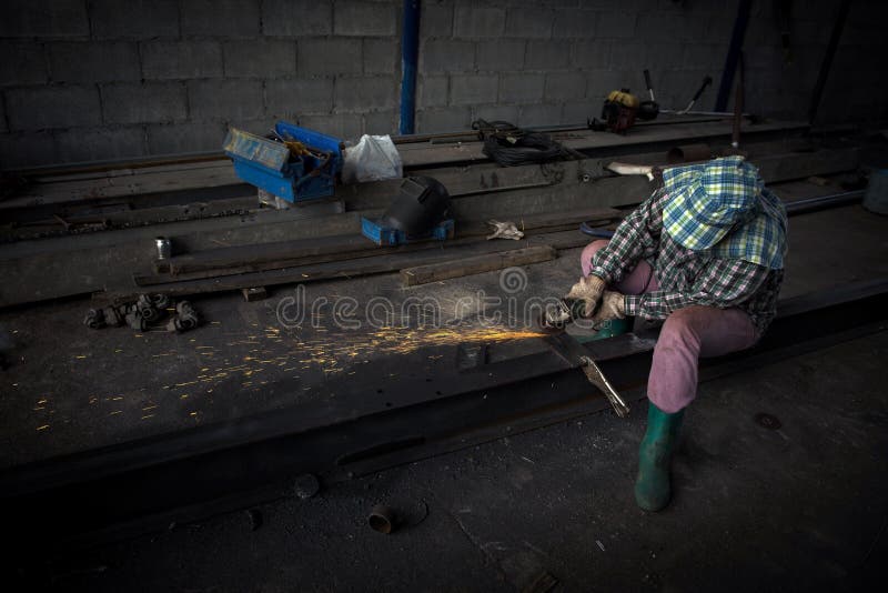 Worker grinding steel stock image. Image of manufacturing - 32499977