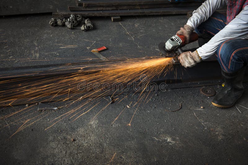 Worker grinding steel stock image. Image of person, manual - 32500061