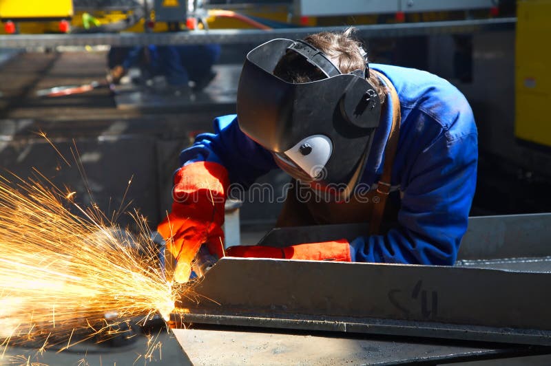 Worker grinding/welding stock photo. Image of protection - 6976642