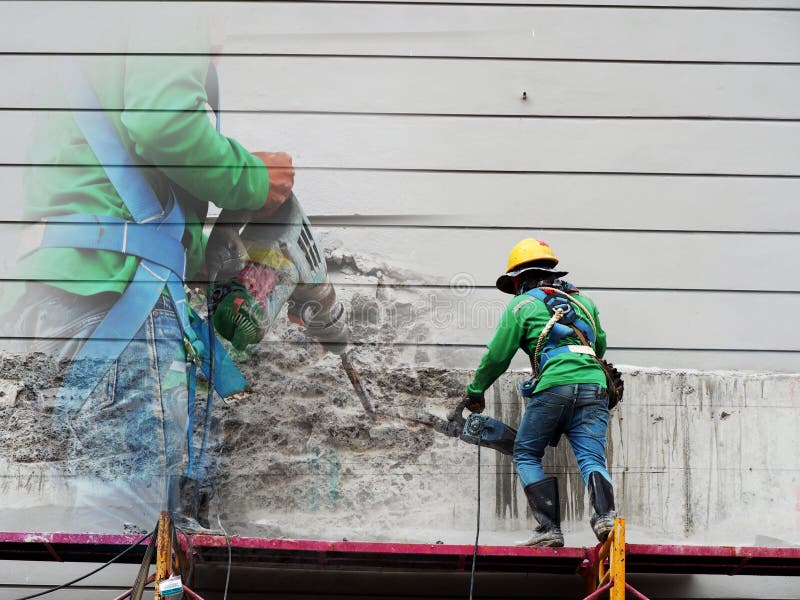 The Man Grinds the Concrete Wall.Grinding the Walls with a Drill and an ...