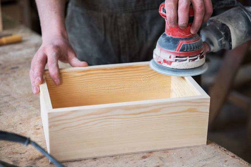 Worker grinds the wood box stock image. Image of power - 140699539