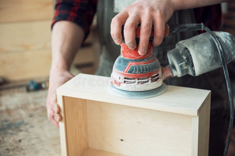 Worker grinds the wood box stock image. Image of grinder - 141566879