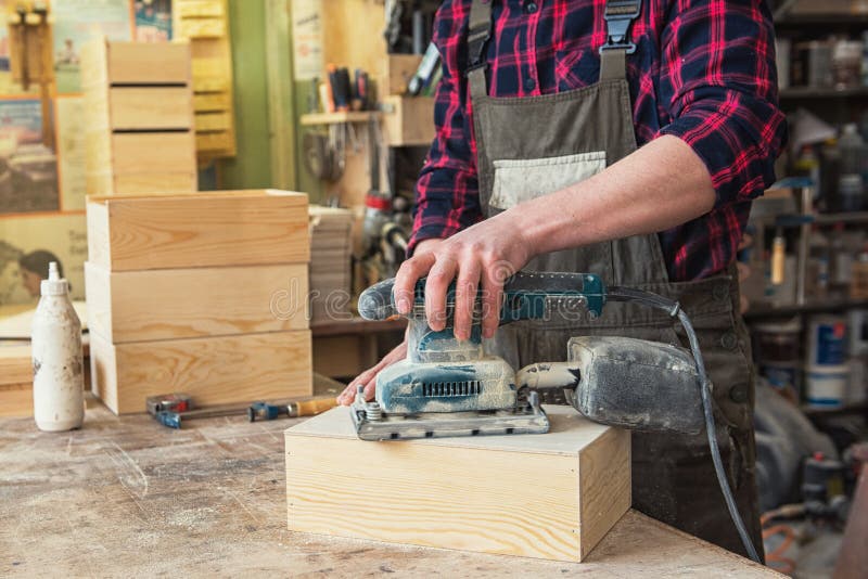 Worker grinds the wood box stock photo. Image of machine - 173740786