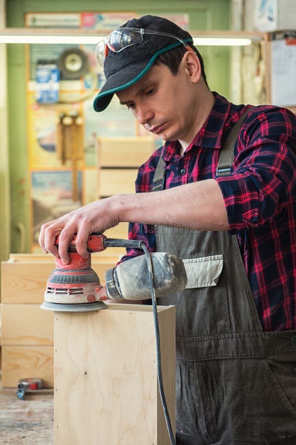 Worker grinds the wood box stock image. Image of equipment - 173740315