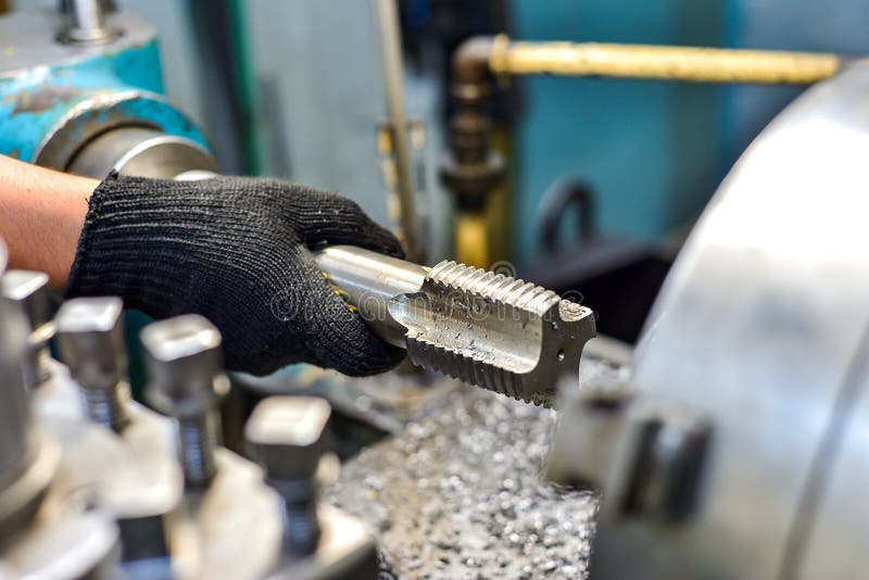 A Worker Guides a Tap on a Part on a Lathe for Internal Threading Stock ...