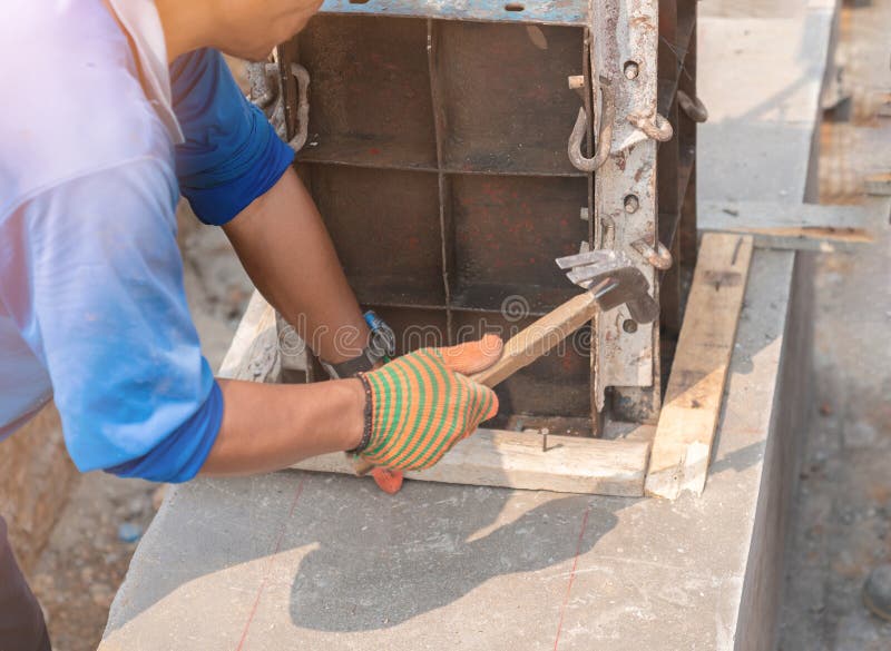 Worker Hammering a Nail into a Plank, Formwork Installation Stock Photo ...