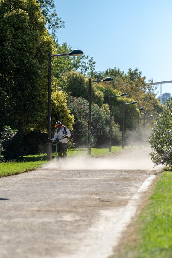 A Worker with a Hand-held Lawn Stock Photo - Image of service ...