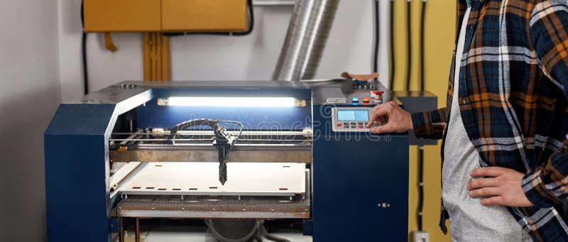 Worker with Hand on Hip Pressing on CNC Machine Stock Photo - Image of ...