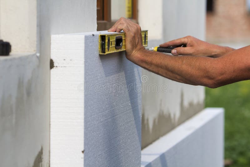 Worker Hand with Level and Knife Measuring and Cutting White Rig Stock ...