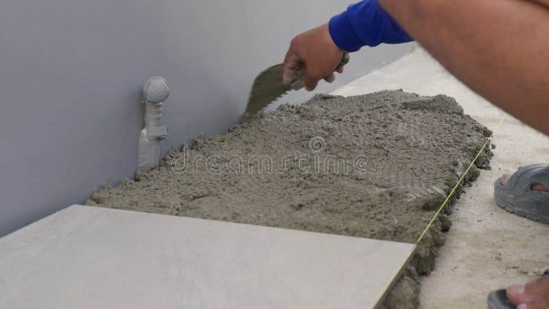 A Worker Hand Uses a Trowel To Smooth Gray Mortar, Preparing a Level ...