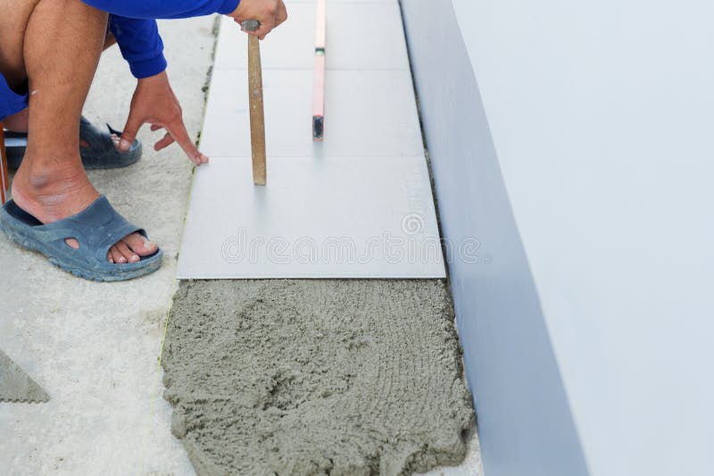 A Worker Hand Uses a Trowel To Smooth Gray Mortar, Preparing a Level ...