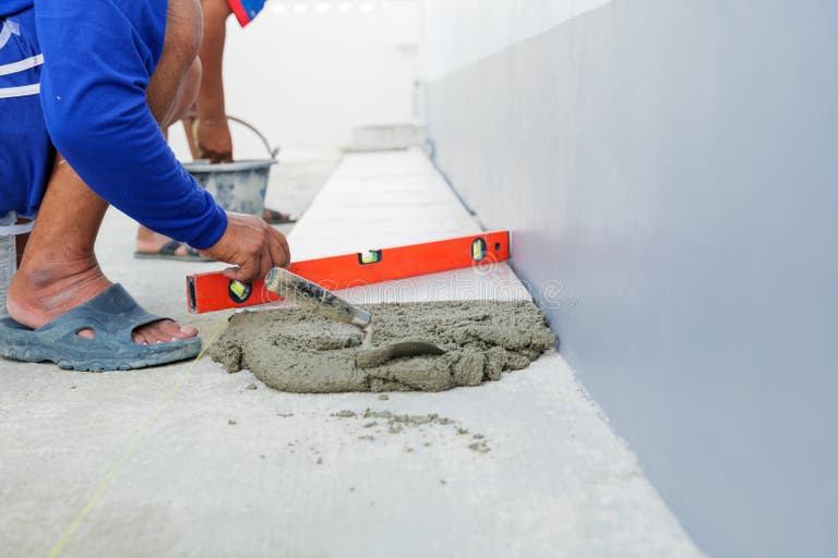 A Worker Hand Uses a Trowel To Smooth Gray Mortar, Preparing a Level ...