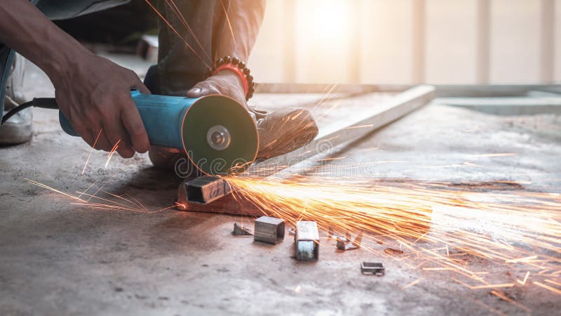 Construction Worker Using Angle Grinder Cutting Metal At Construction ...