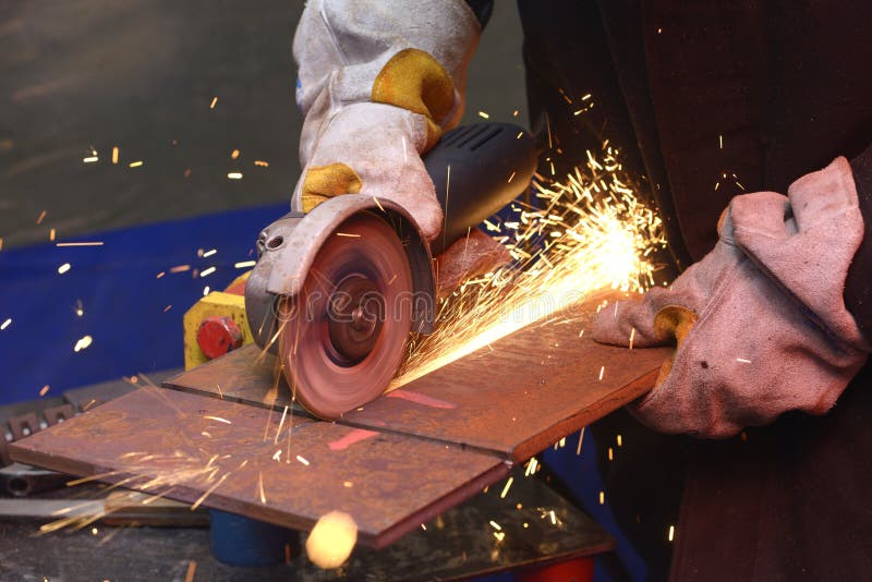 Worker Hands Grinding Metal Plate with a Grinder, Preparing for Welding ...