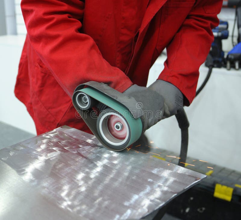 Worker Hands Sanding Metal Sheet by the Hand Held Belt Sender Stock ...