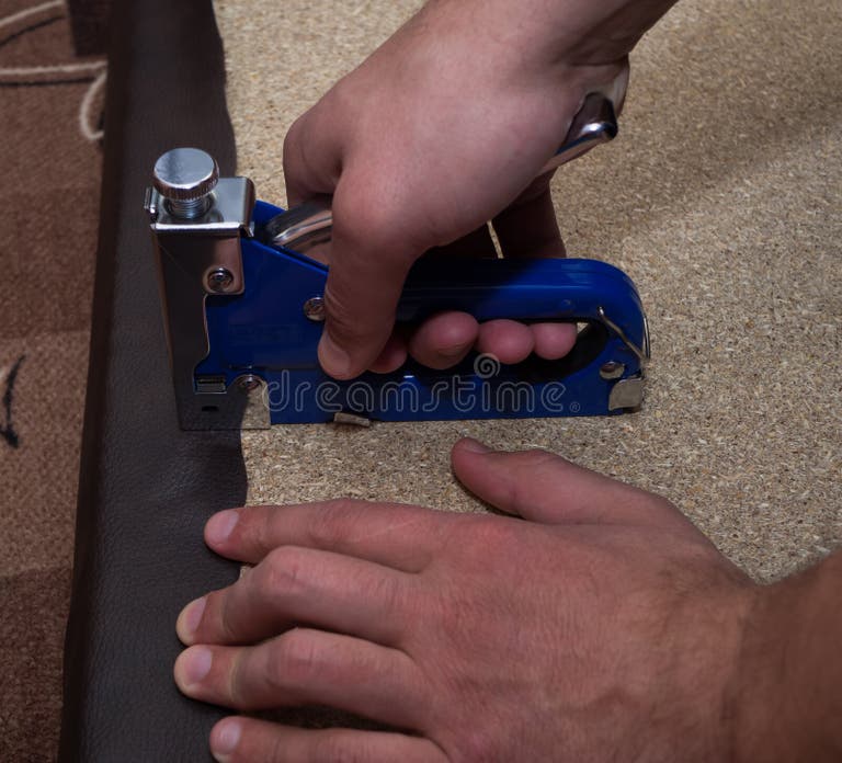 Worker Hands Using Stapler and Leather Upholstering the Paricle Board ...