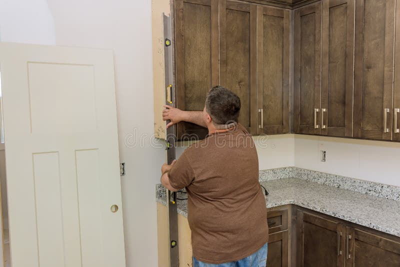A Worker Hangs a Level for the Purpose of Leveling Out a Set of New ...