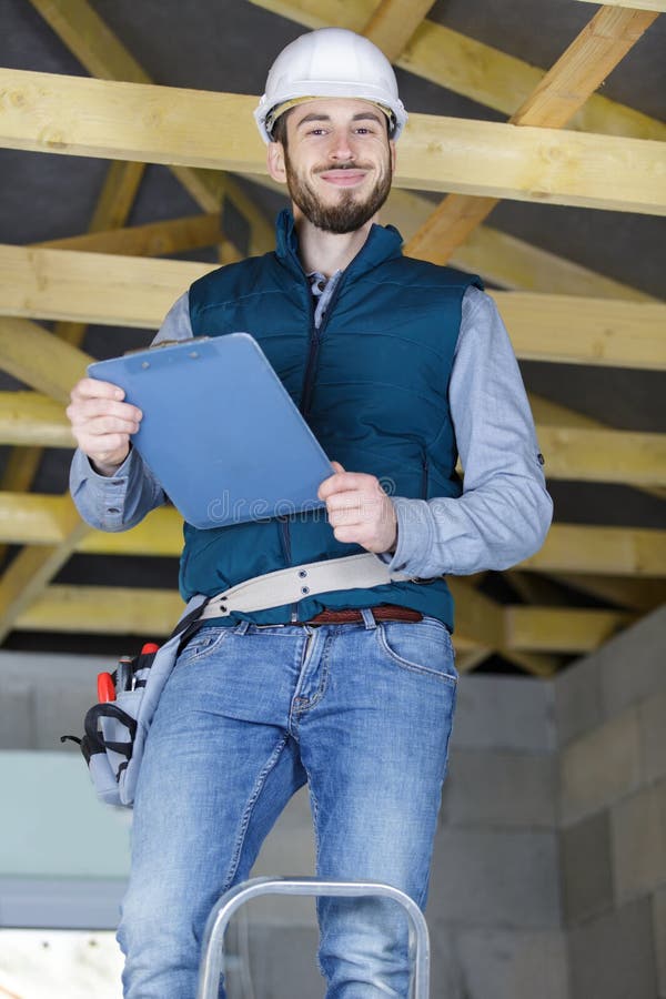 Worker in Hard Hat Holding Black Clipboard and Thinking Stock Image ...