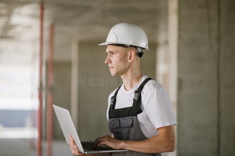 Worker in Hard Hat Working on Laptop Stock Photo - Image of employment ...