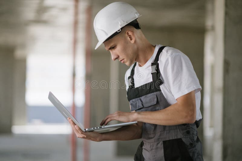 Worker in Hard Hat Working on Laptop Stock Image - Image of architect ...